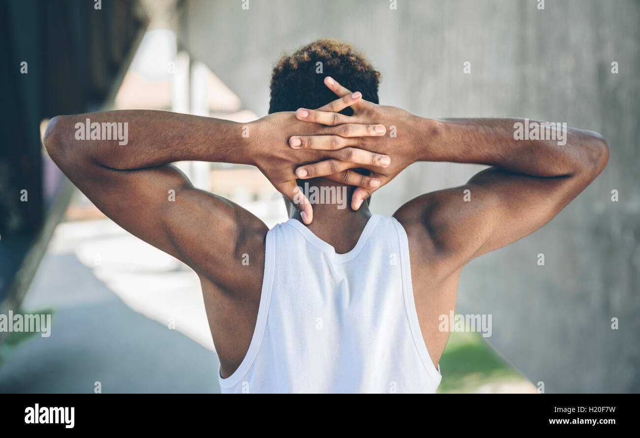 Back view of young man doing stretching exercises Stock Photo - Alamy