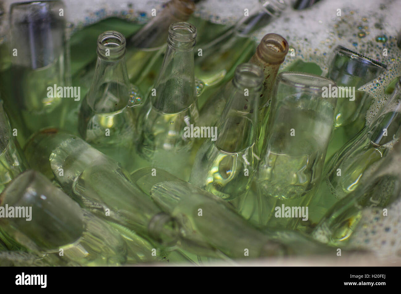 Bottles being washed in water Stock Photo - Alamy