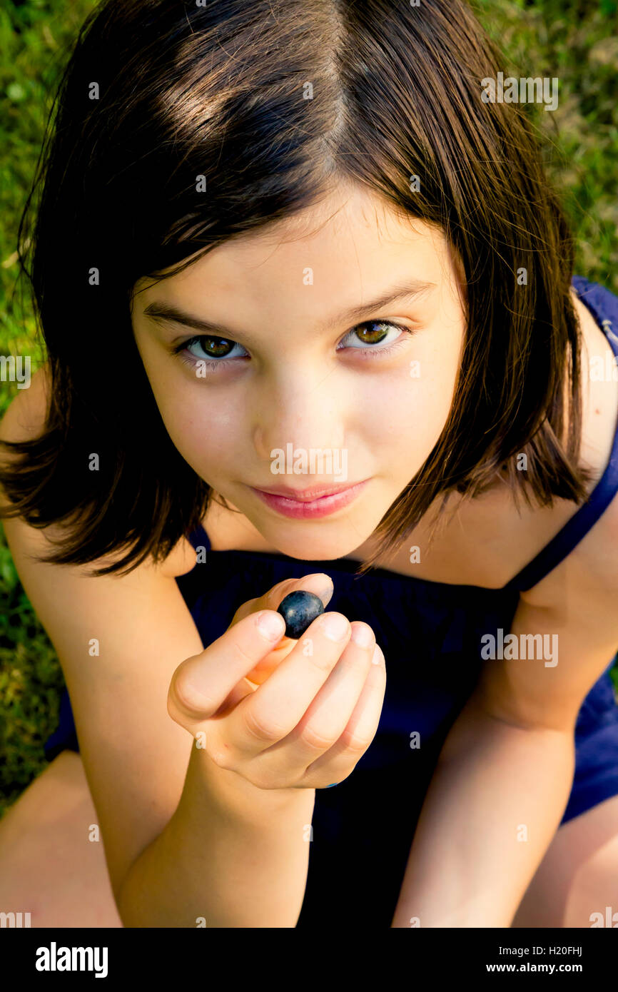 Girl eating blueberries Stock Photo - Alamy