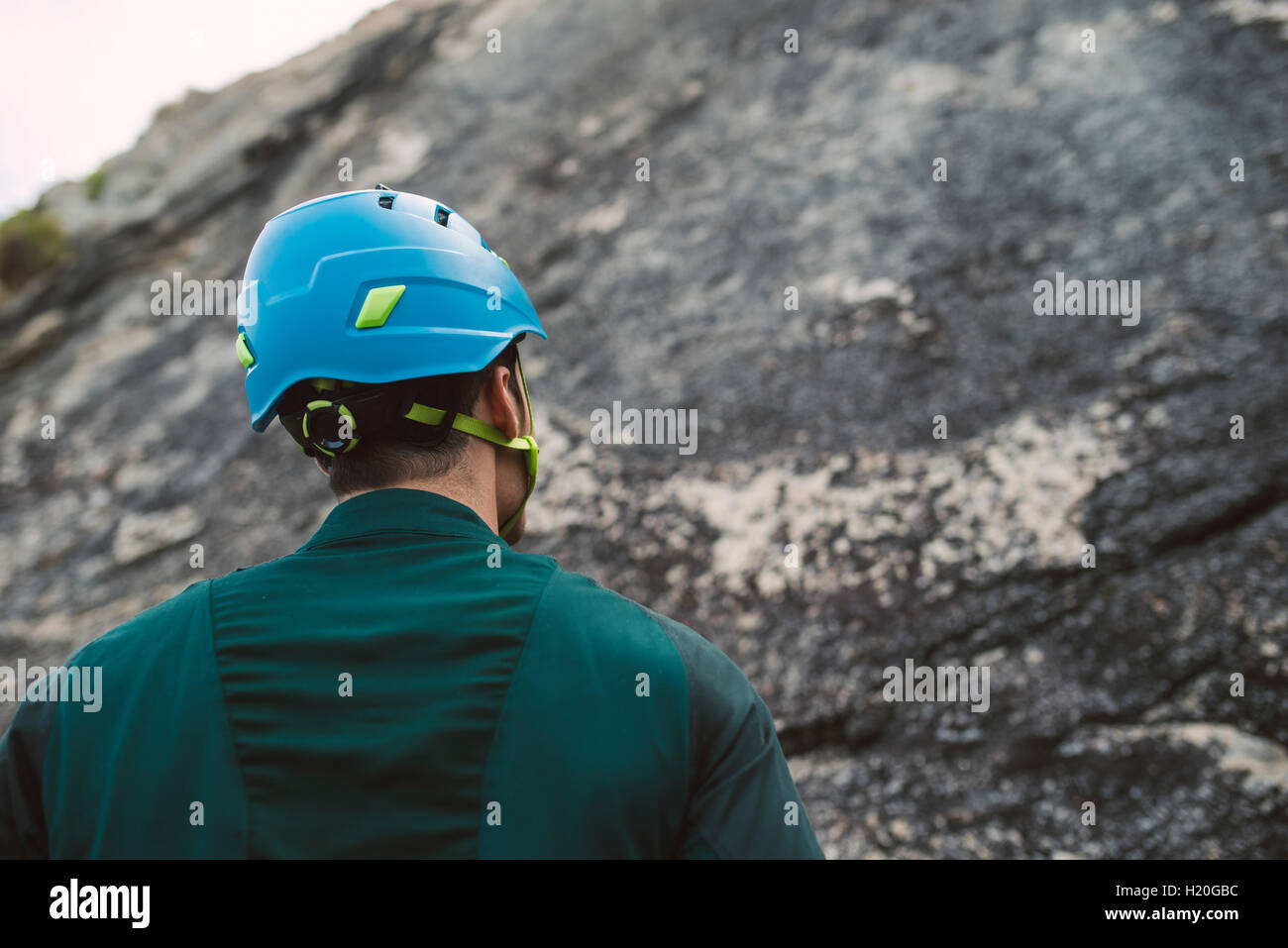 Climber looking up a rock wall Stock Photo - Alamy
