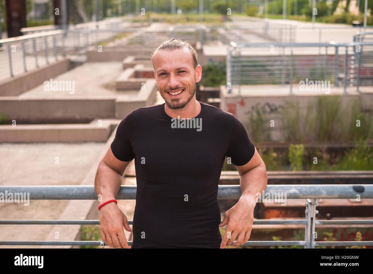Portrait of content man leaning on railing Stock Photo - Alamy