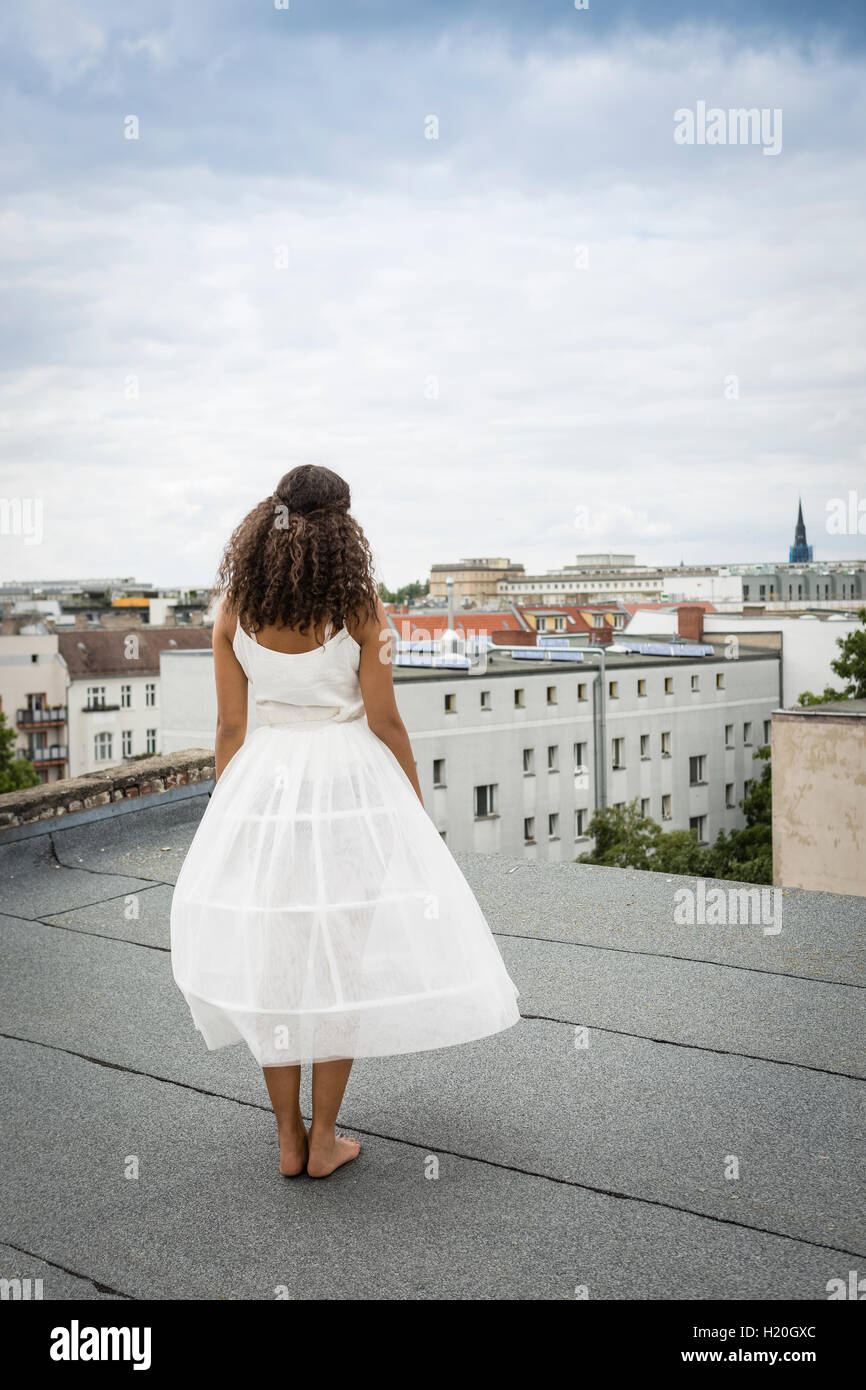 Back view of young ballet dancer standing on a roof top Stock Photo - Alamy