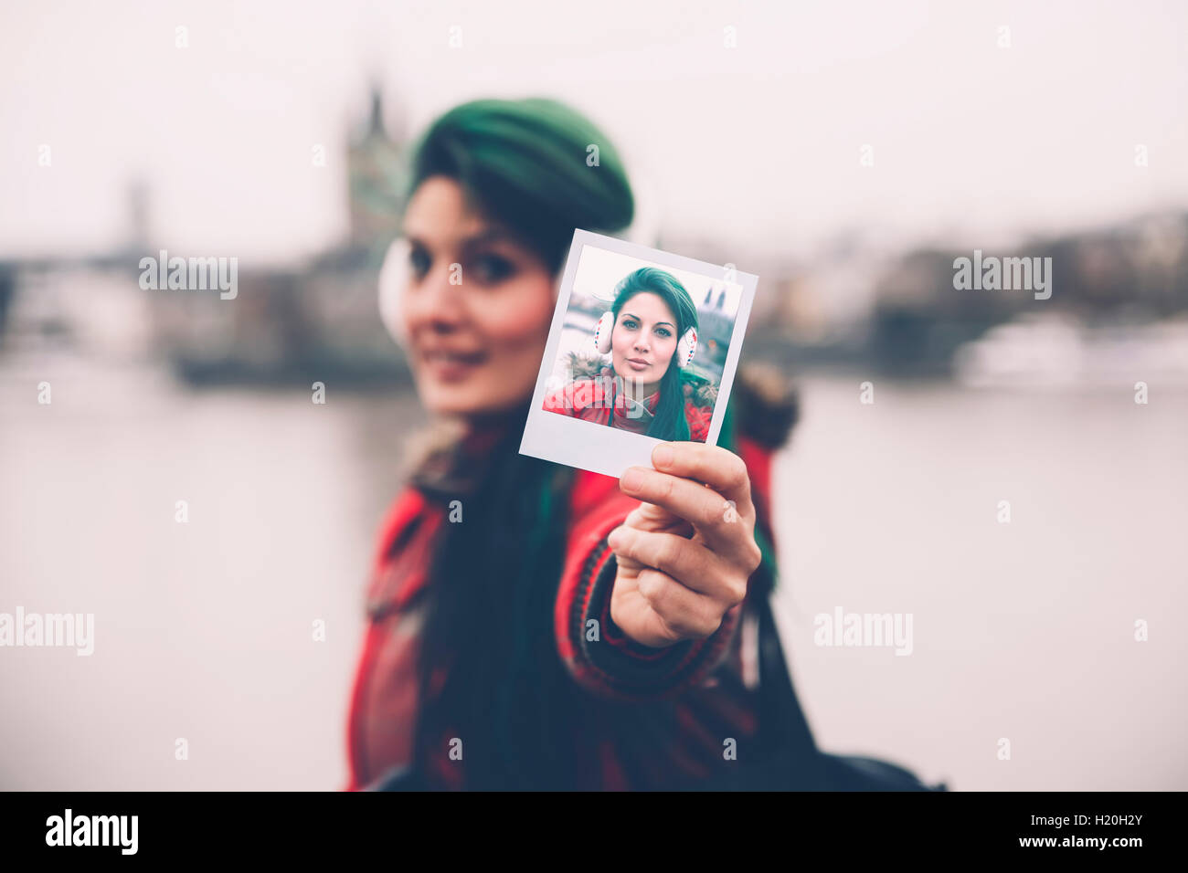 Germany, Cologne, woman showing polaroid of herself Stock Photo - Alamy