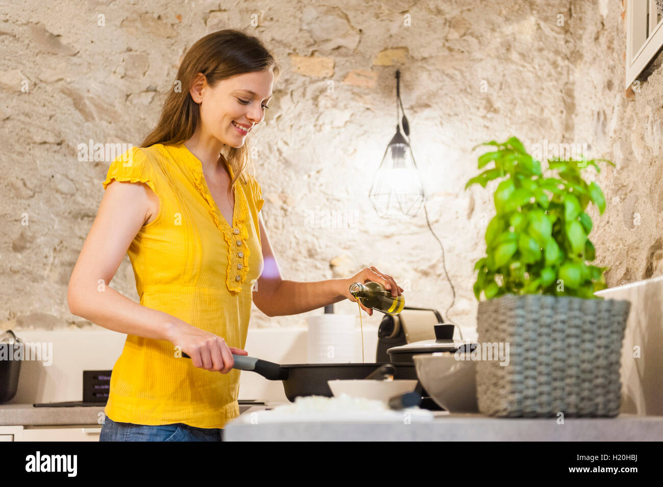Woman in kitchen preparing spaghetti sauce Stock Photo - Alamy