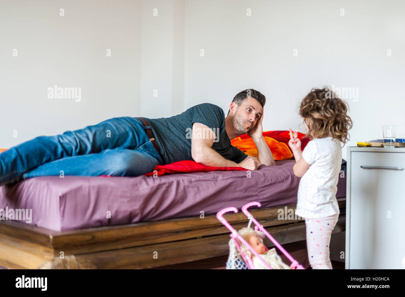 Father and daughter with doll in bedroom Stock Photo - Alamy