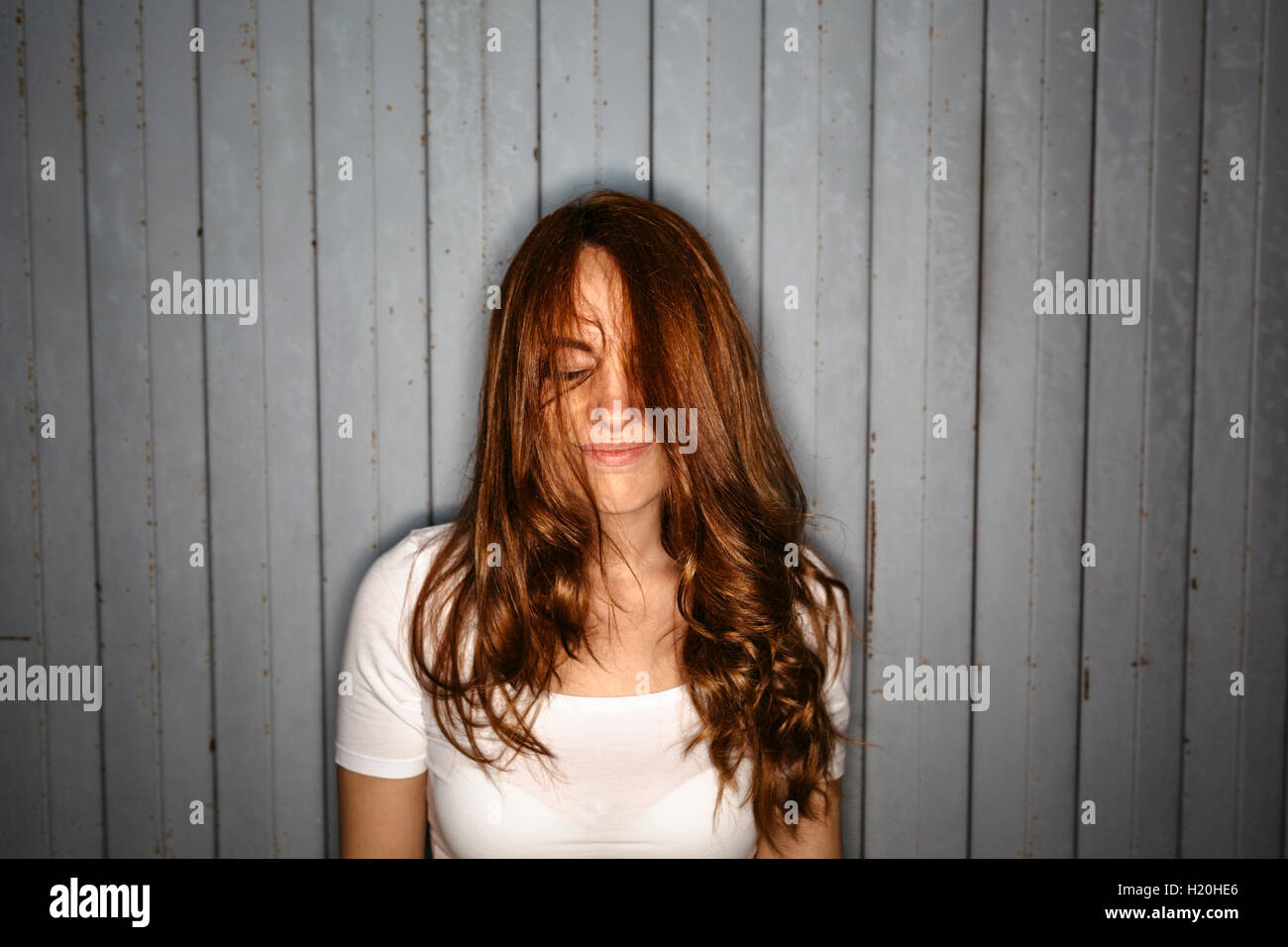 Redheaded young woman with dishevelled hair Stock Photo - Alamy