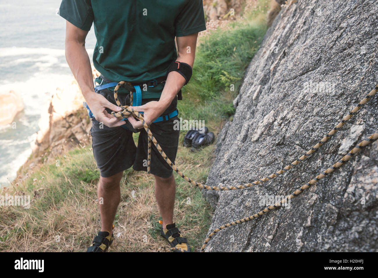 Climber preparing to climb a rock Stock Photo - Alamy