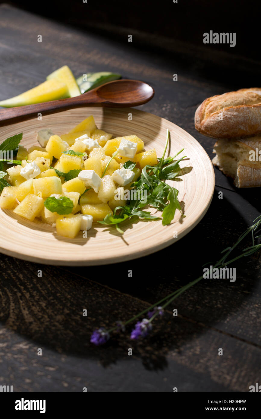 Melon salad, yellow watermelon, feta, mint and rocket on plate Stock ...
