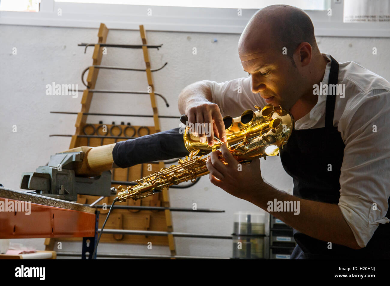 Instrument maker using a scraper during a saxophone repair Stock Photo ...