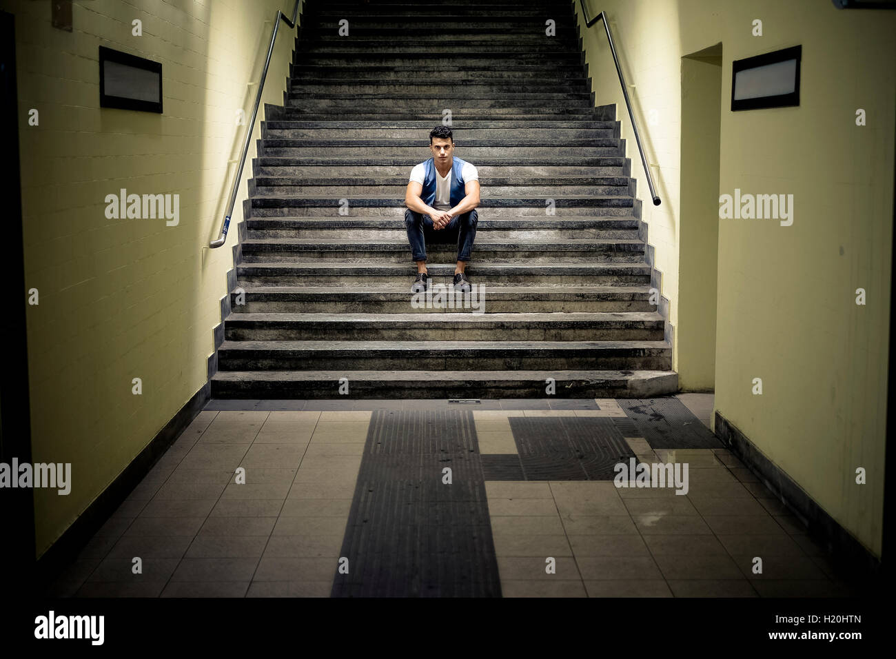 Man sitting on stairs Stock Photo - Alamy