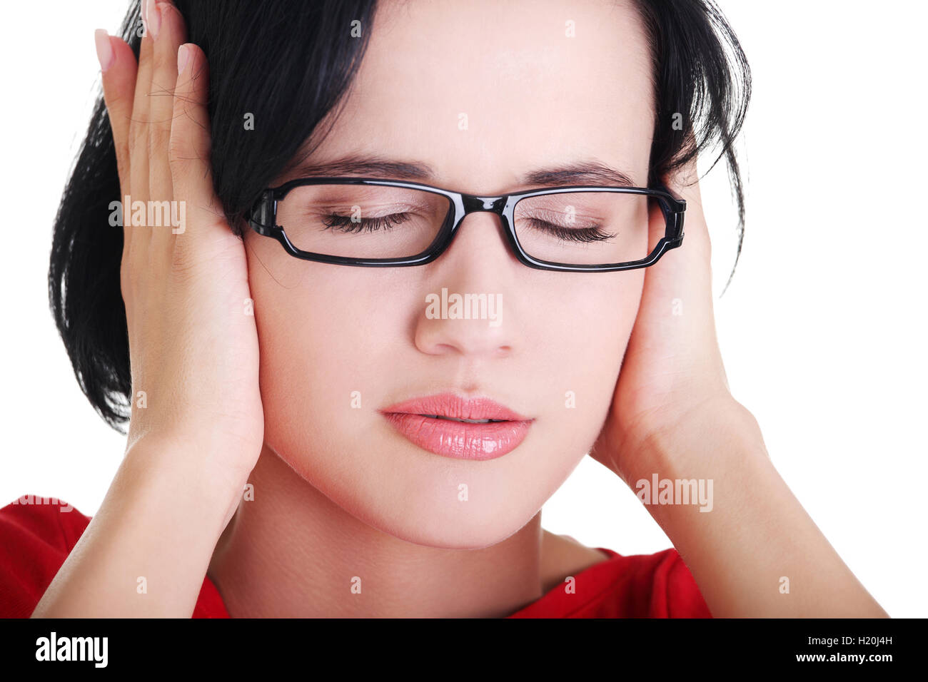 Frustrated young woman holding her ears Stock Photo - Alamy