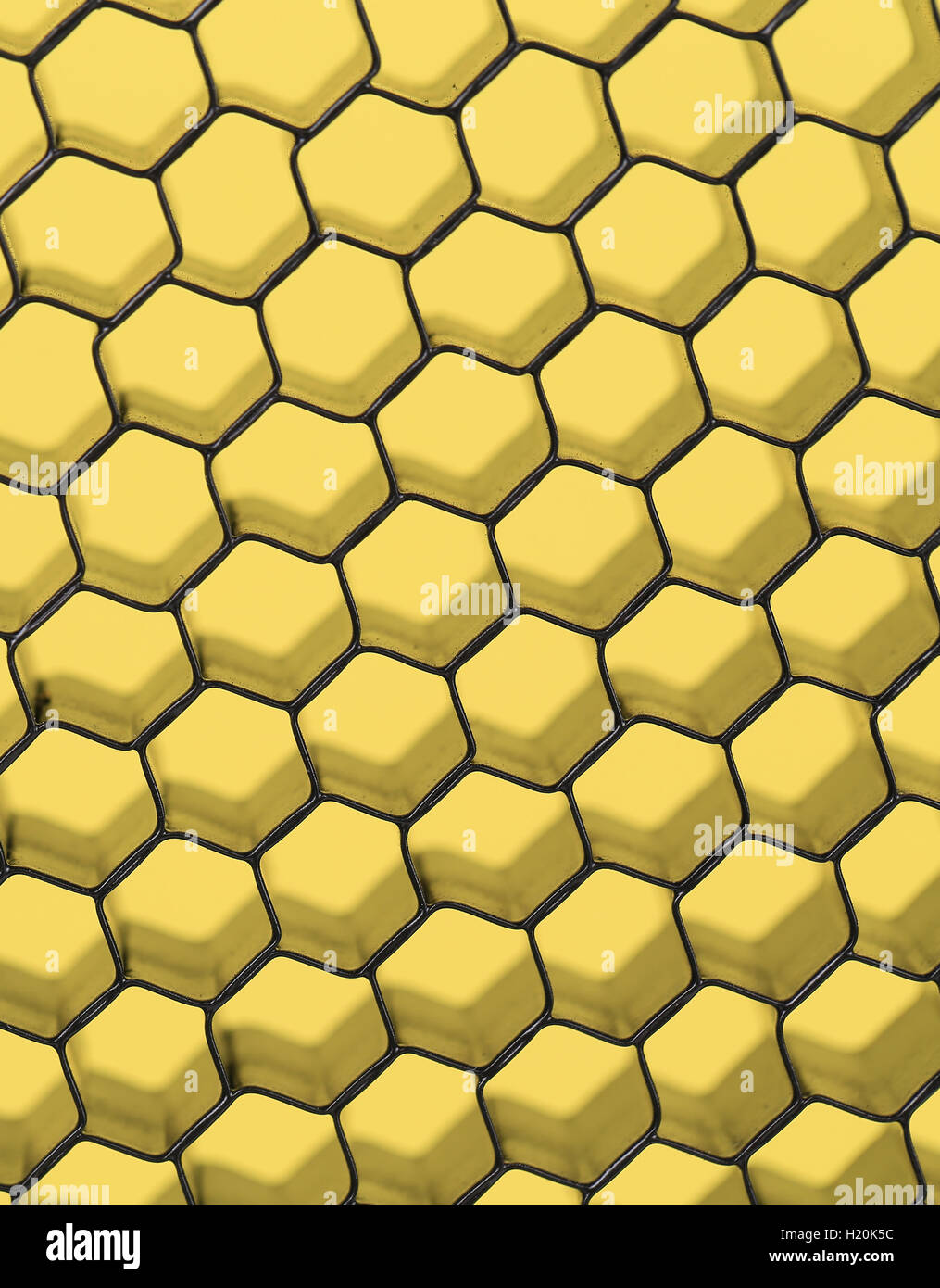 Close up of black net. Yellow light Stock Photo - Alamy