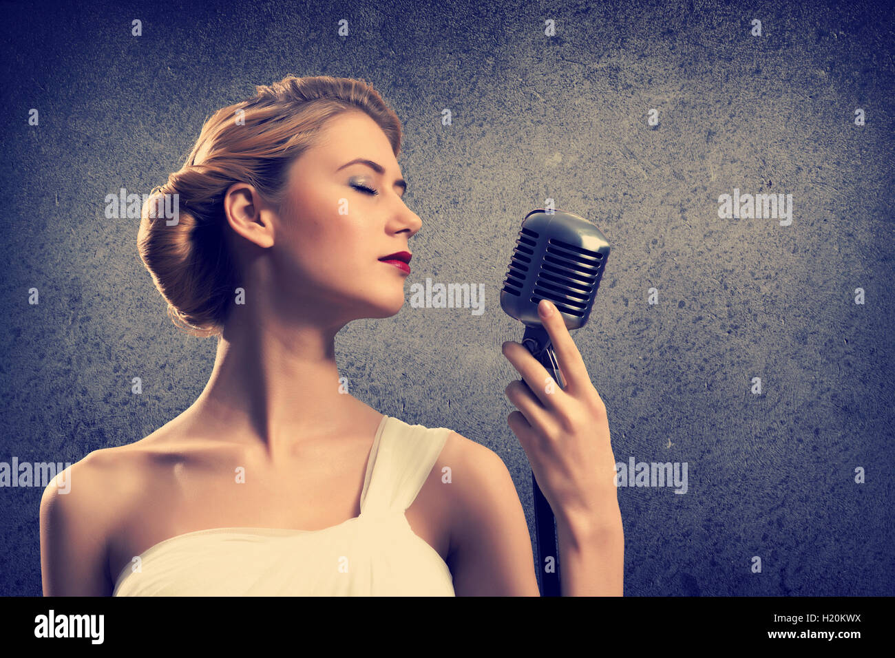 attractive female singer with microphone Stock Photo - Alamy