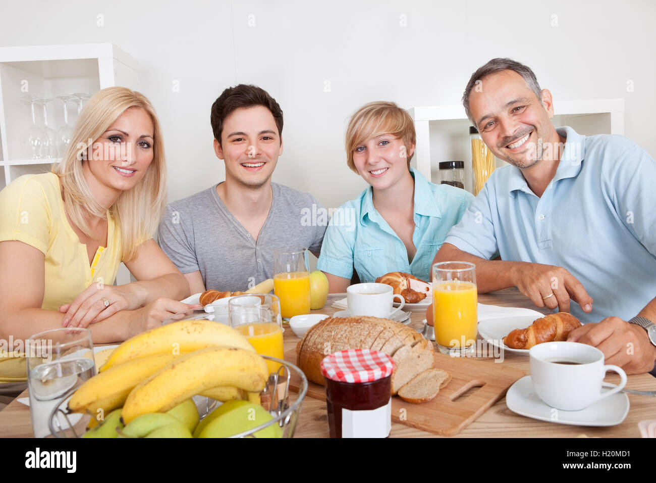 Happy family enjoying breakfast Stock Photo - Alamy