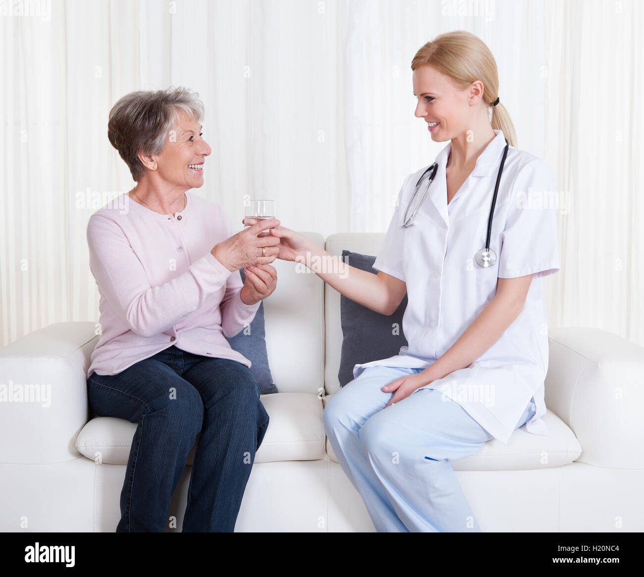 Portrait Of Doctor And Patient Sitting On Couch Stock Photo - Alamy