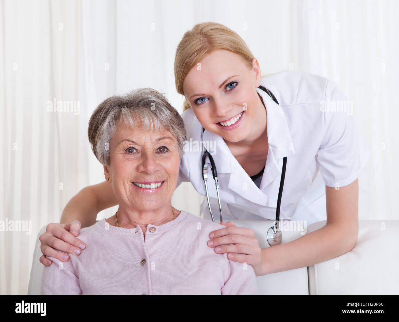 Portrait Of Doctor And Patient Sitting On Couch Stock Photo - Alamy