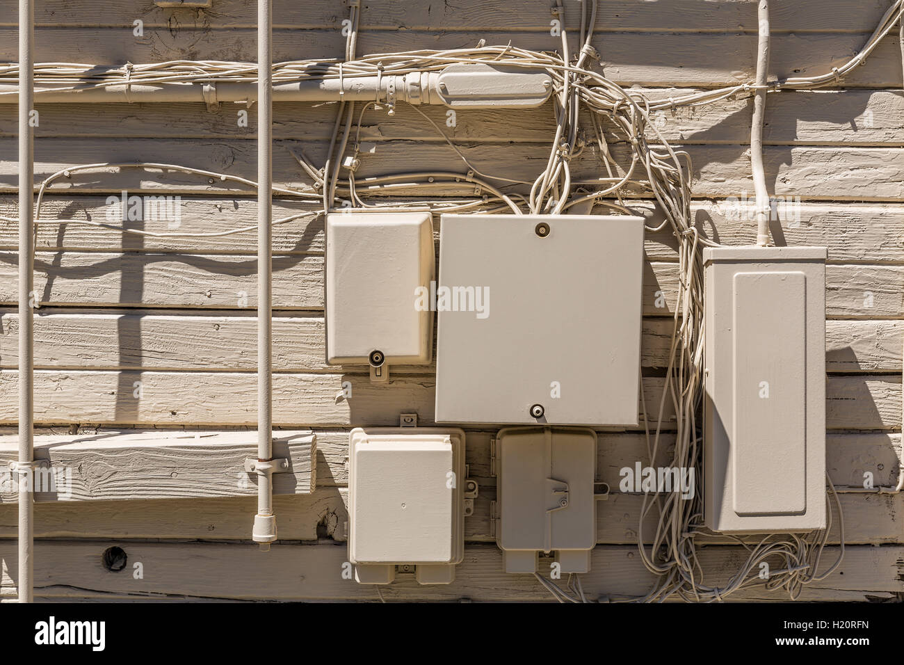 Messy cables and electrical boxes in a wooden beige wall Stock Photo ...