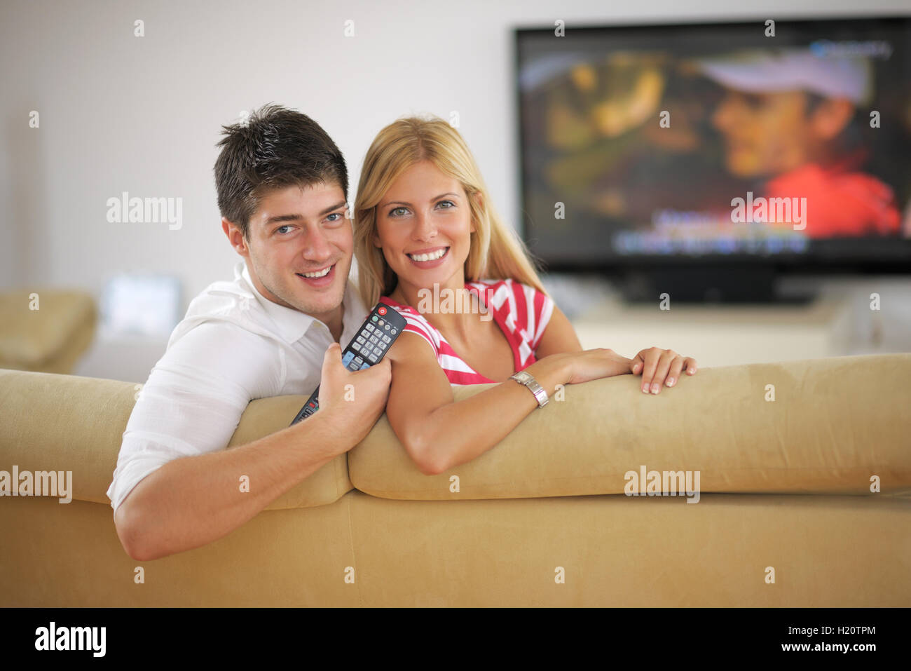 Relaxed young couple watching tv at home Stock Photo - Alamy