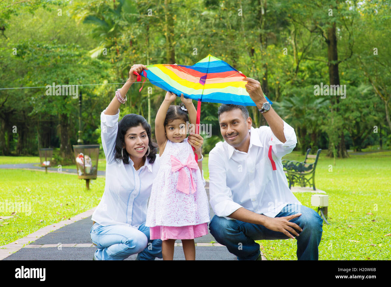 Parents flying kite with child Stock Photo - Alamy