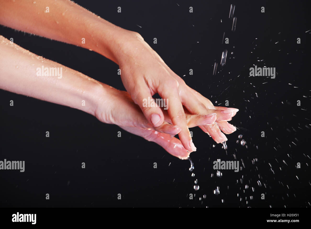 Water falling on female hands Stock Photo - Alamy