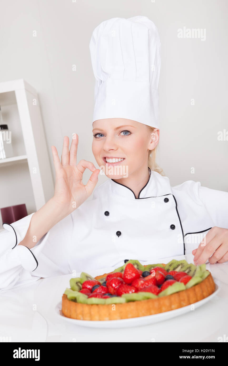 Beautiful chef woman making cake Stock Photo - Alamy