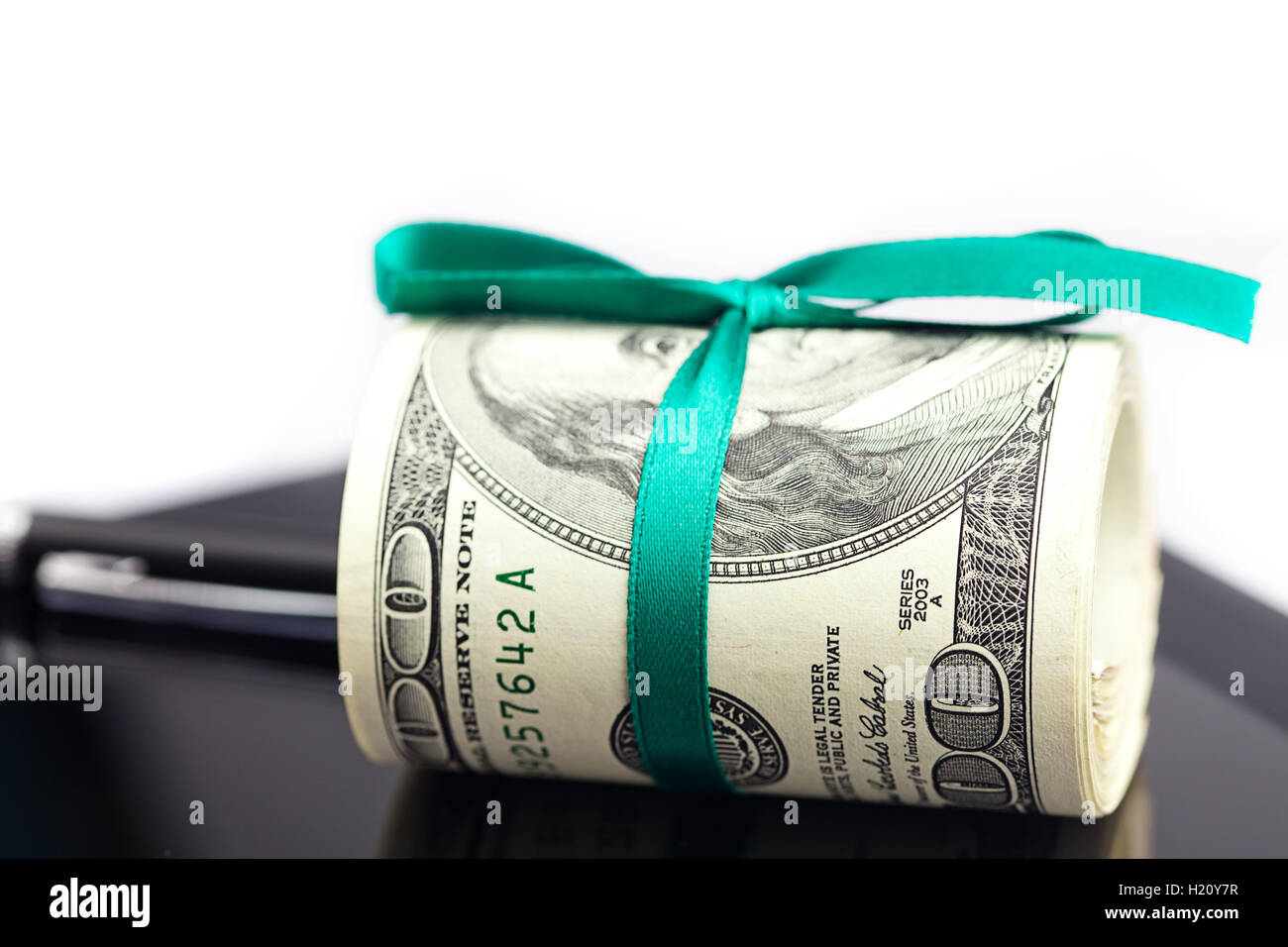 tablet,tube of dollars and stylus isolated on white Stock Photo - Alamy