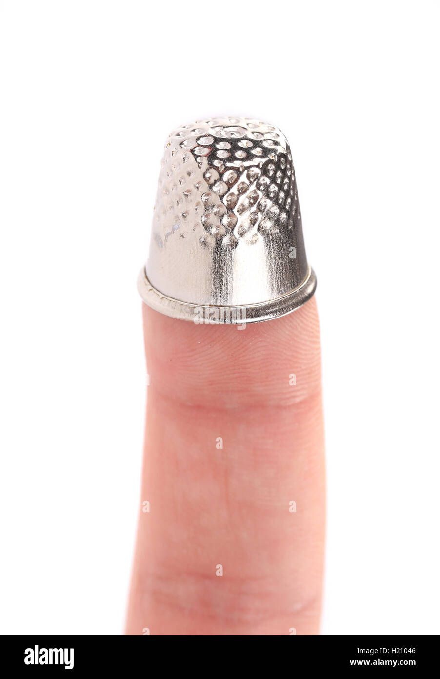 Metal sewing thimble on finger Stock Photo - Alamy