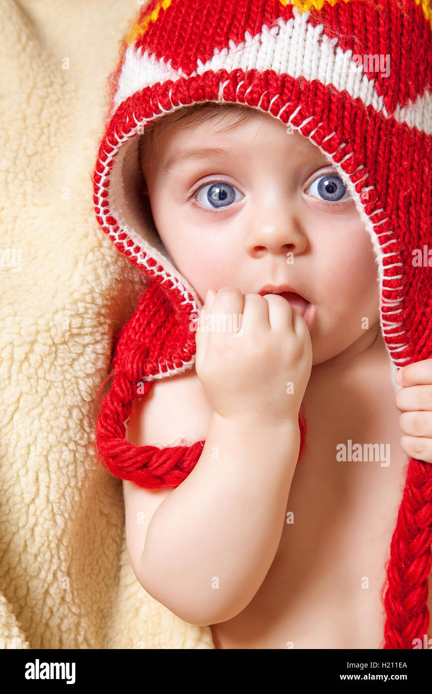 Baby in red bonnet Stock Photo - Alamy