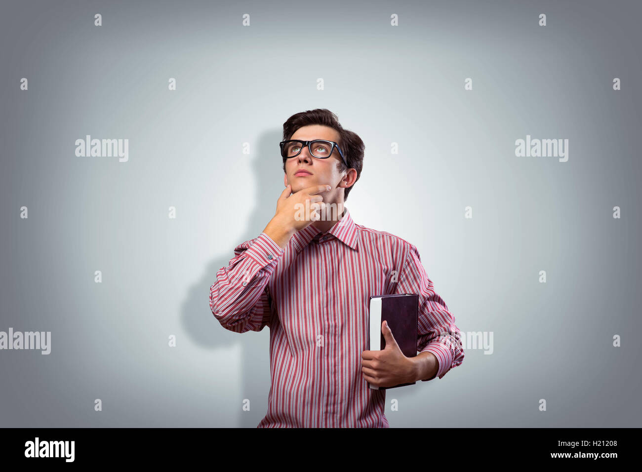 young man scientist with glasses thinking Stock Photo - Alamy