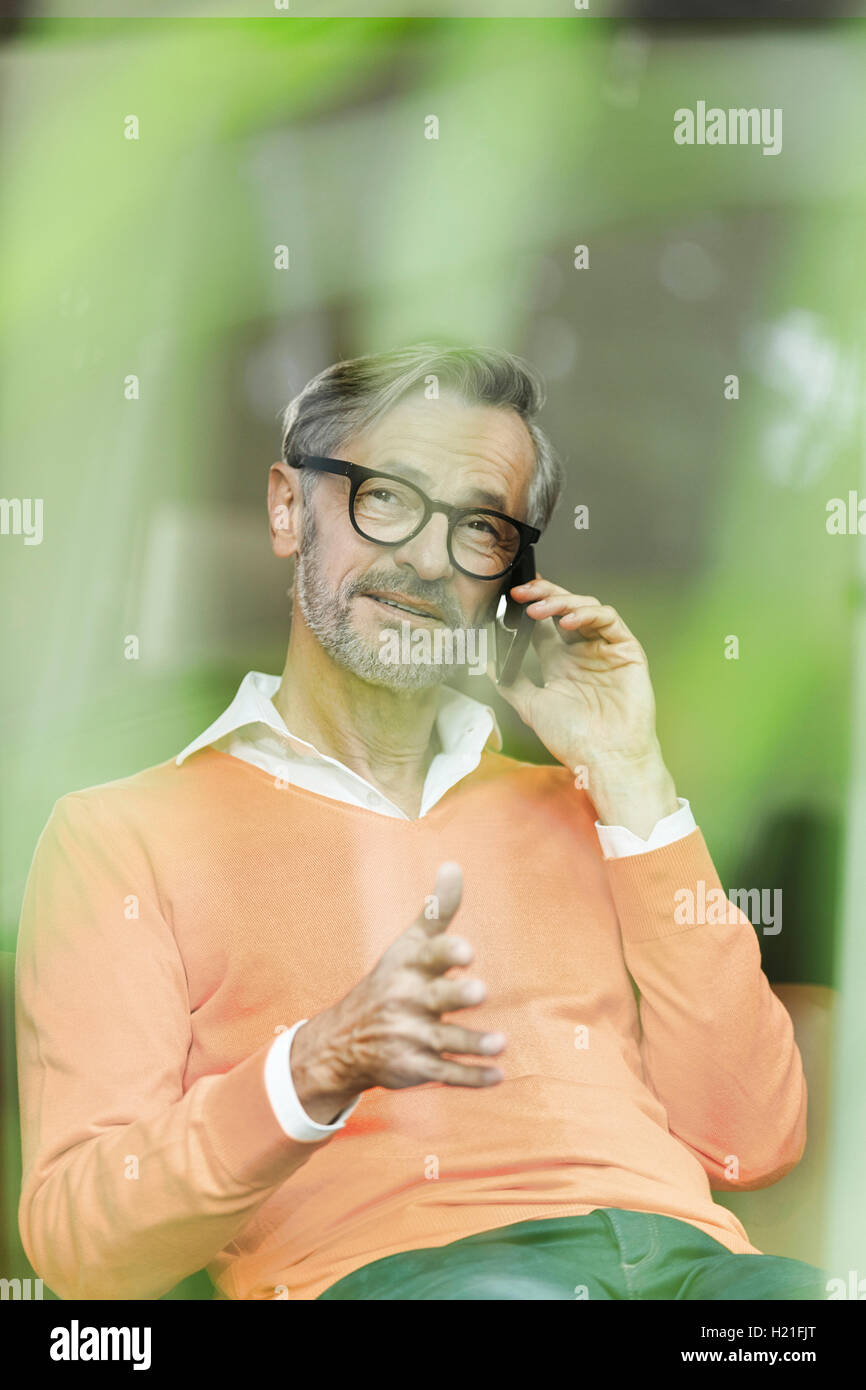 Man on the phone looking through window Stock Photo - Alamy