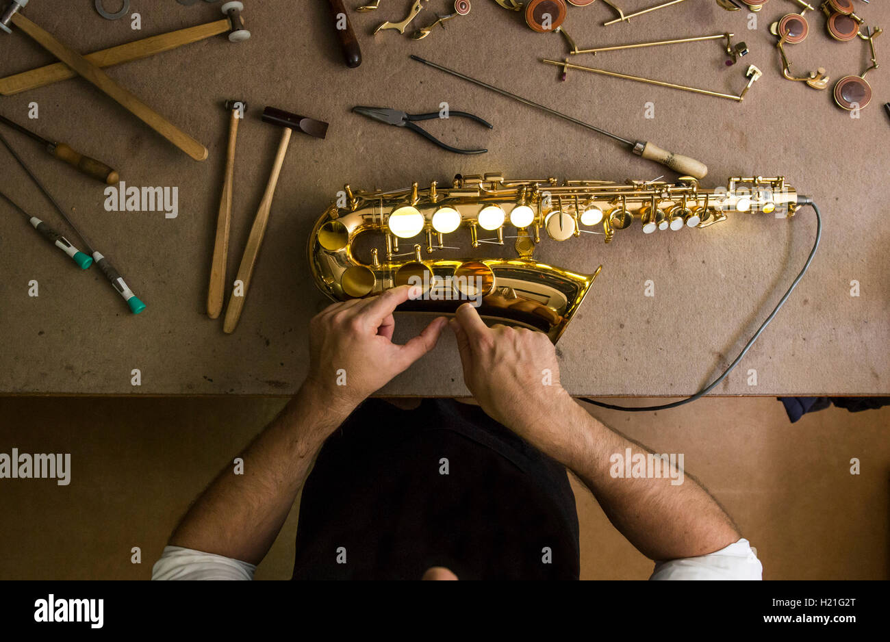 Instrument maker repairing a saxophone Stock Photo - Alamy