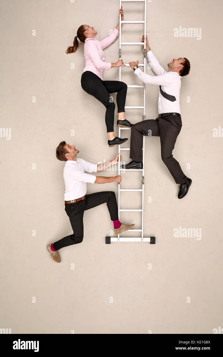 Three business colleagues climbing ladder Stock Photo - Alamy