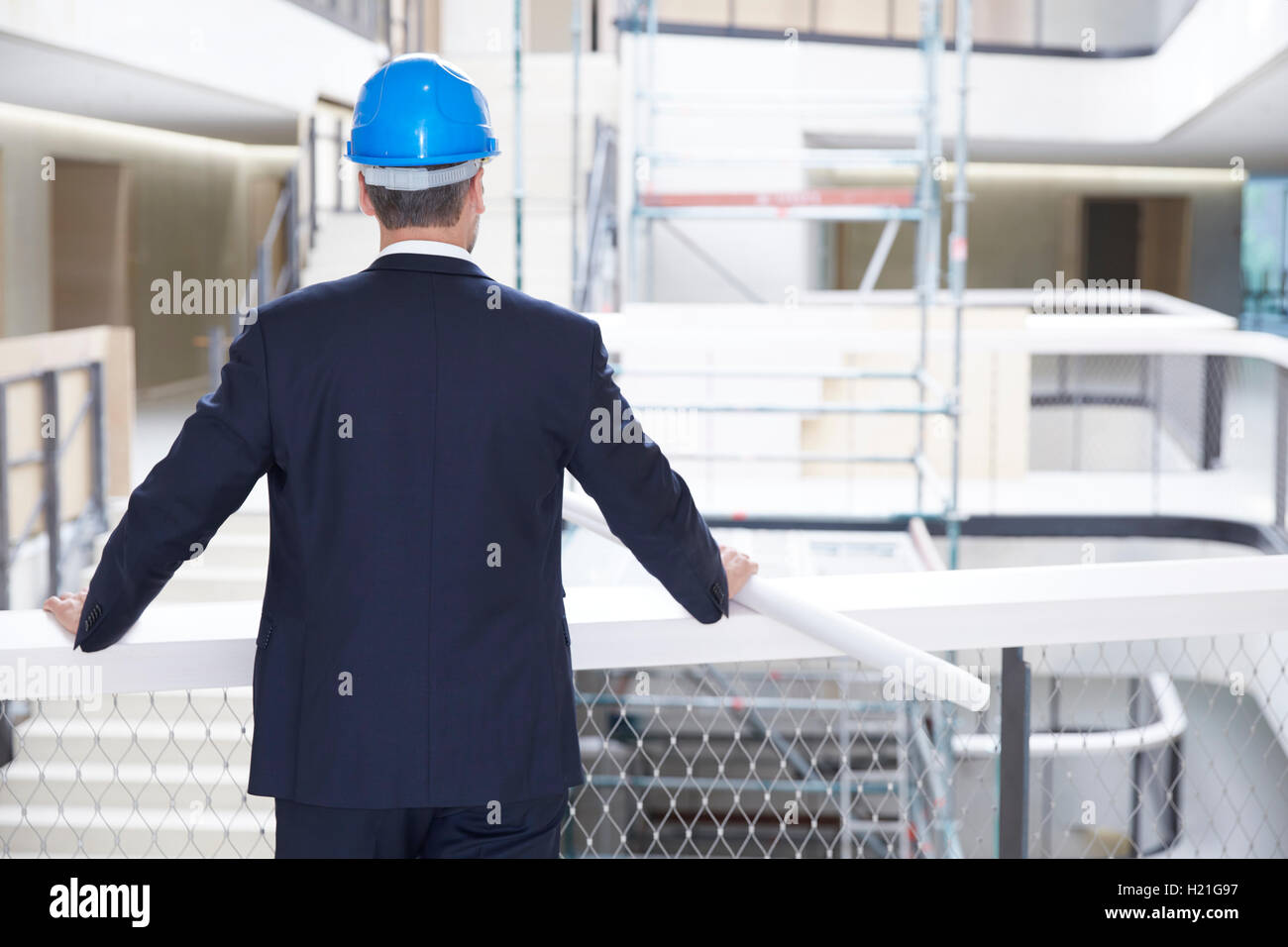 Architect on construction site wearing hard hat Stock Photo - Alamy