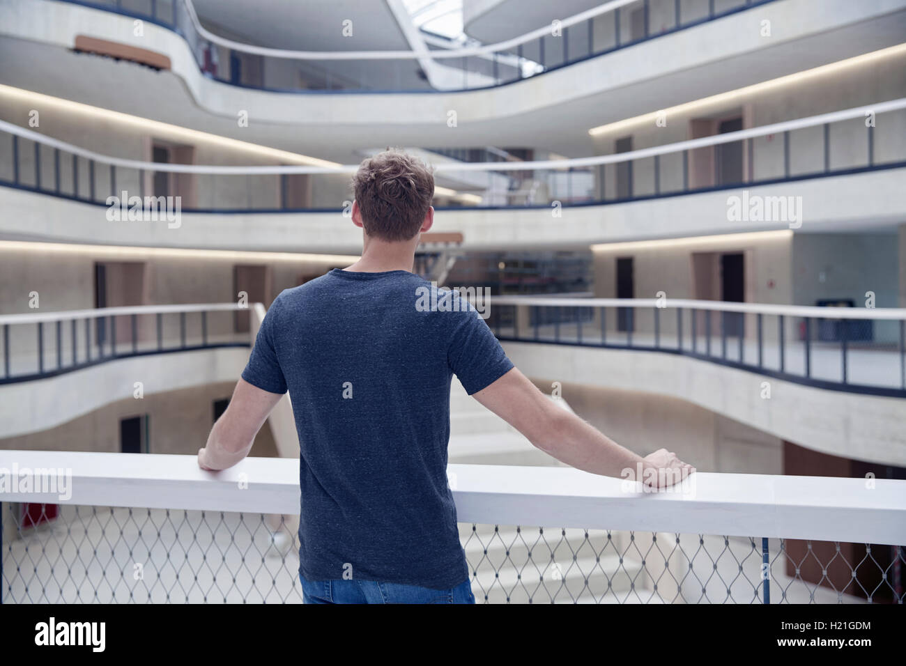 Young man in modern office building Stock Photo - Alamy