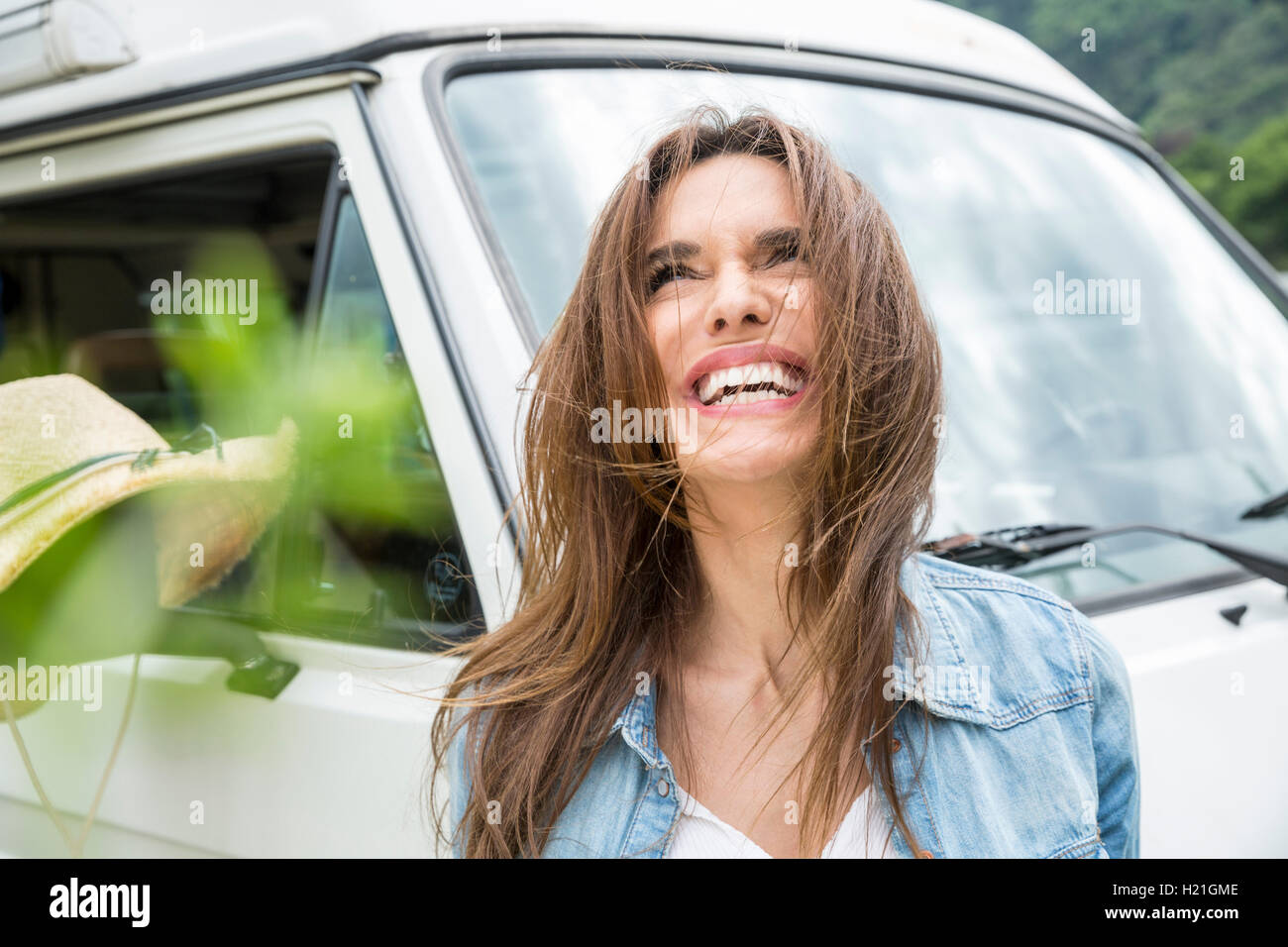 Laughing woman beside van Stock Photo - Alamy