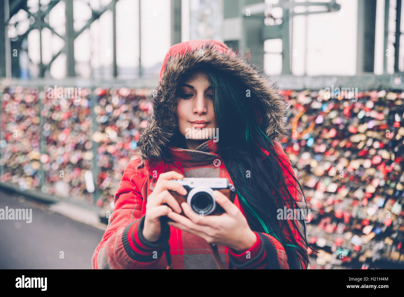 Germany, Cologne, woman with camera at Hohenzollern Bridge Stock Photo ...