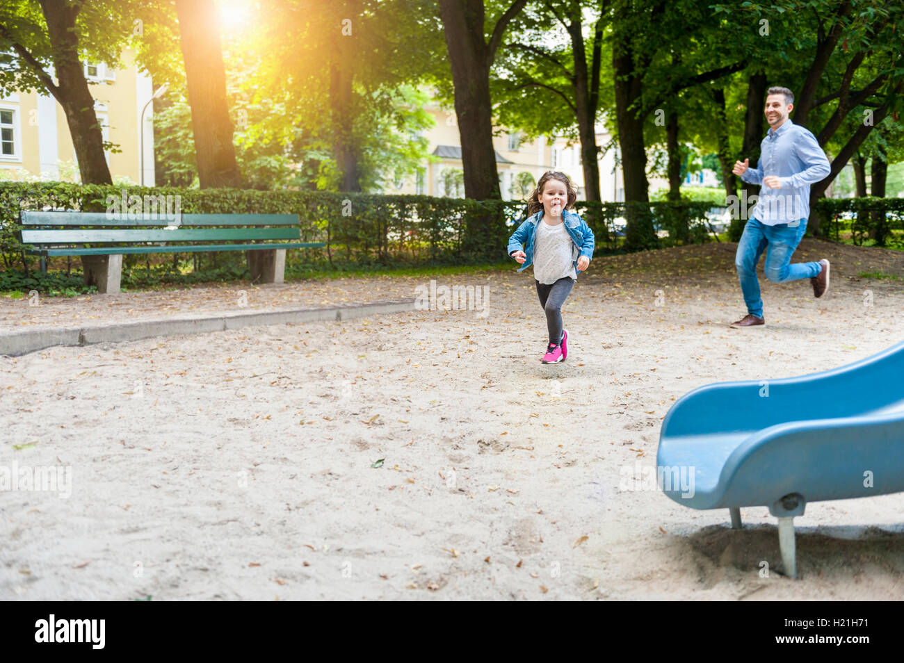 Father running with daughter on playground Stock Photo - Alamy