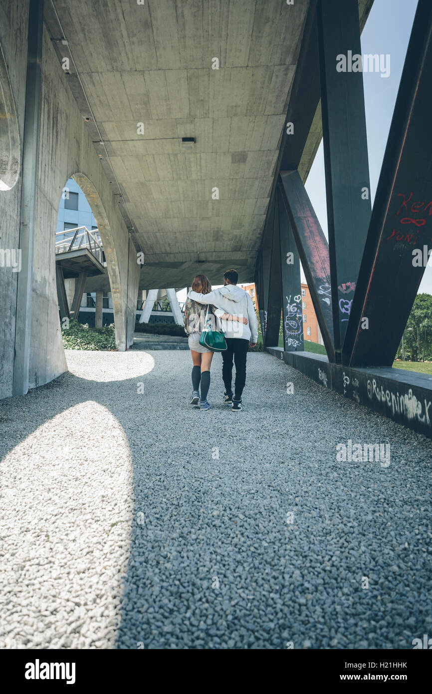 Back view of young couple in love walking arm in arm Stock Photo - Alamy