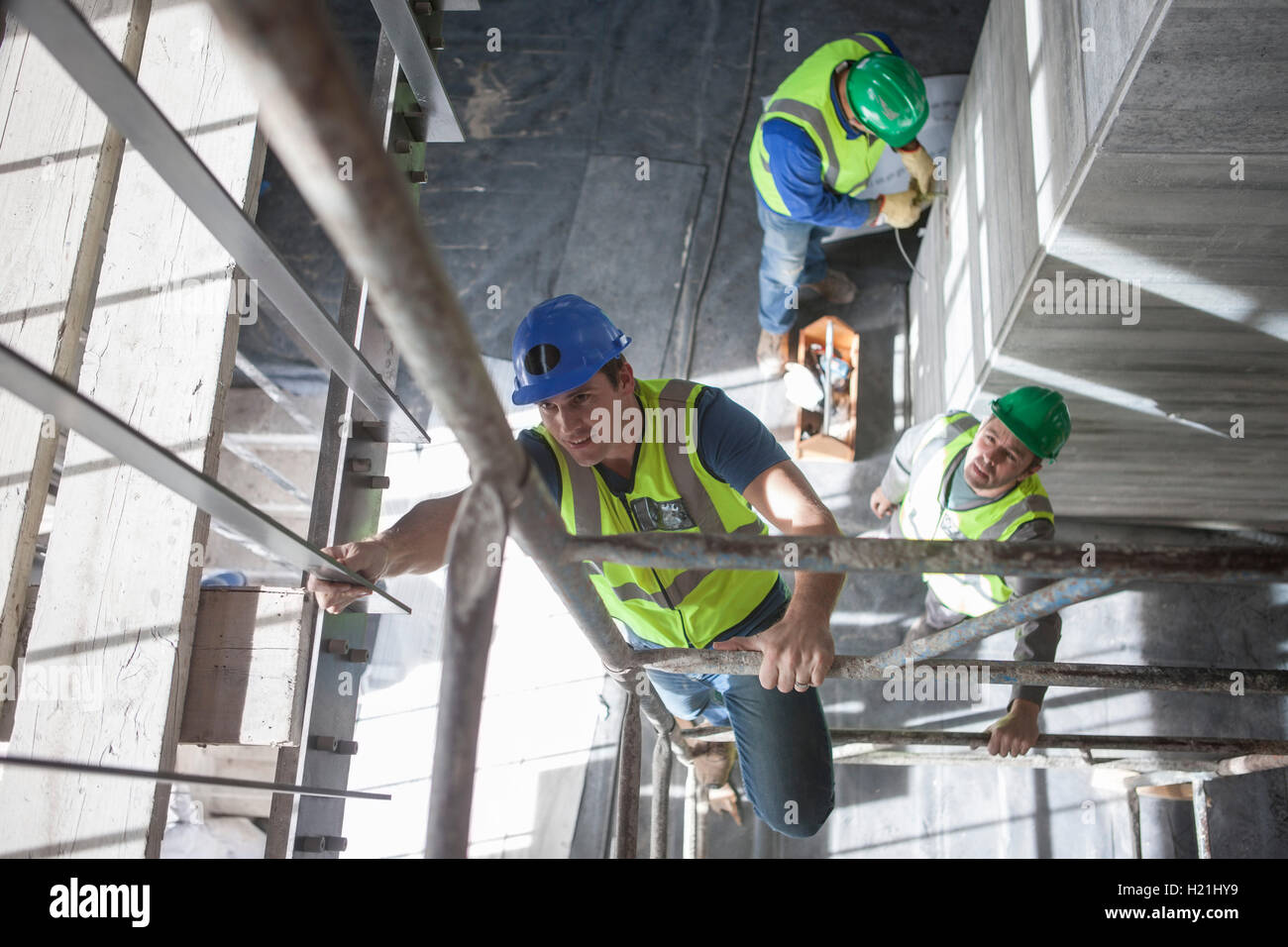 Construction workers working on construction site Stock Photo - Alamy
