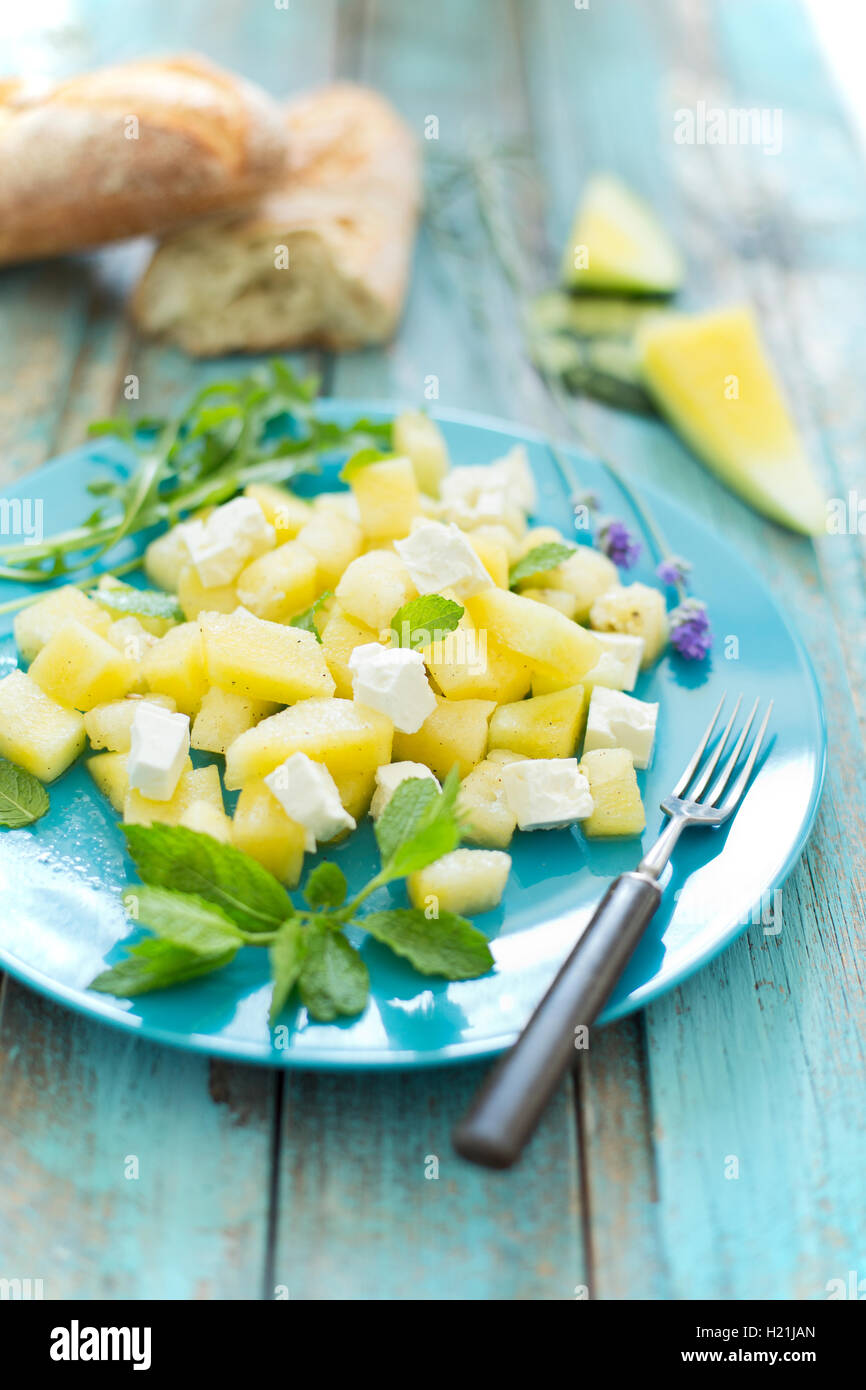 Melon salad, yellow watermelon, feta, mint and rocket on plate Stock ...