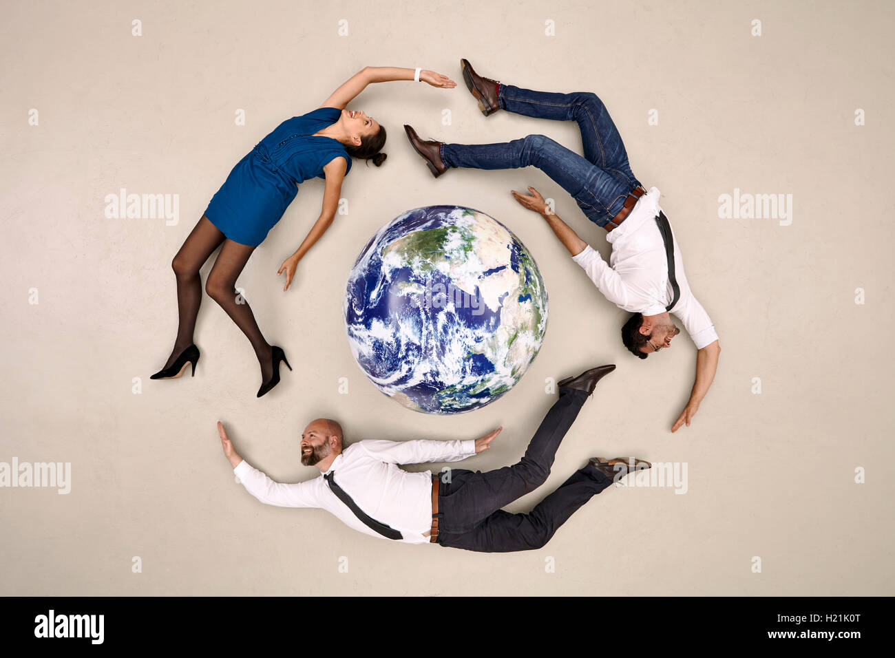 Three business colleagues flying around the globe Stock Photo - Alamy