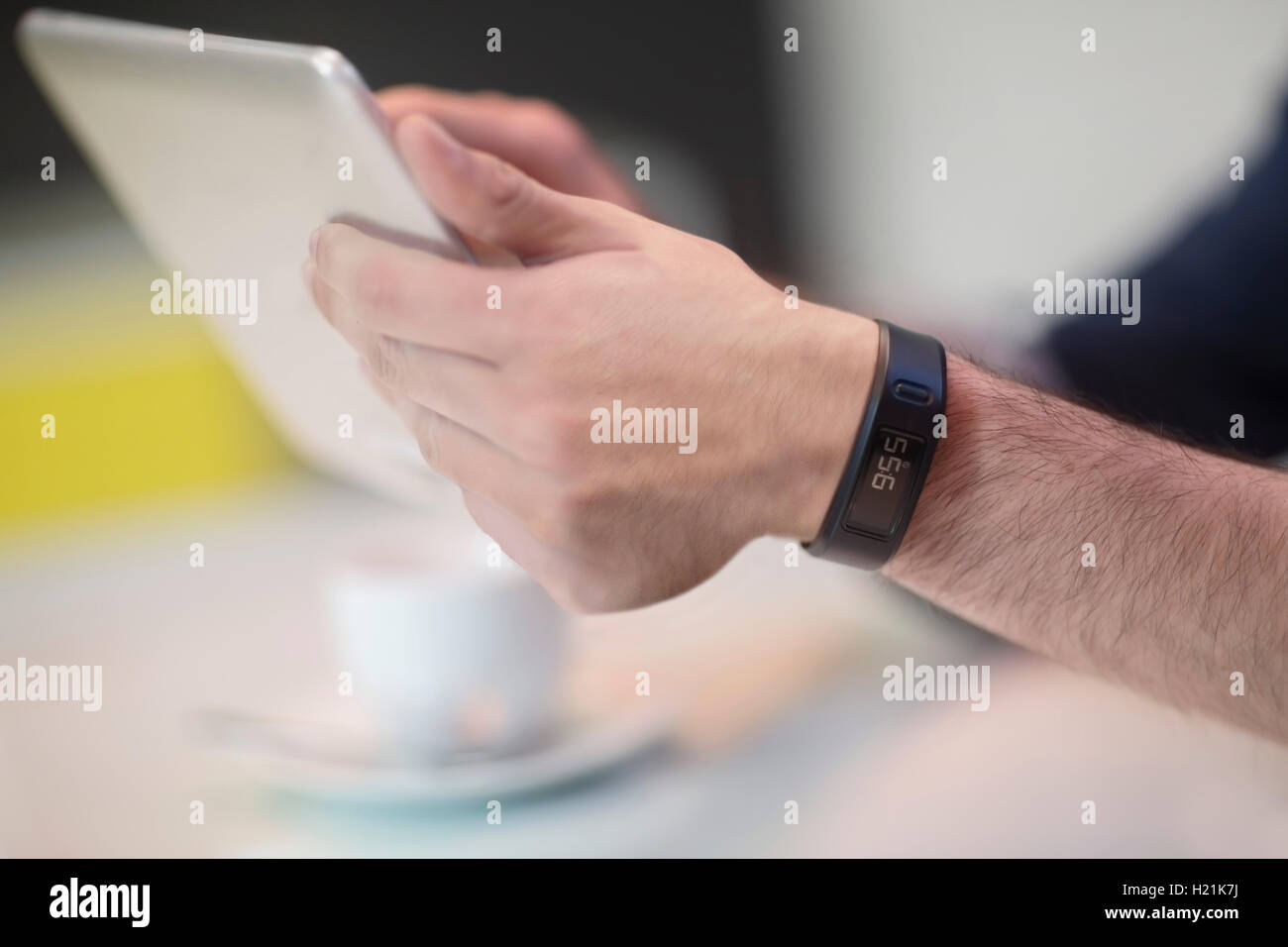 Man wearing smartwatch using tablet Stock Photo - Alamy