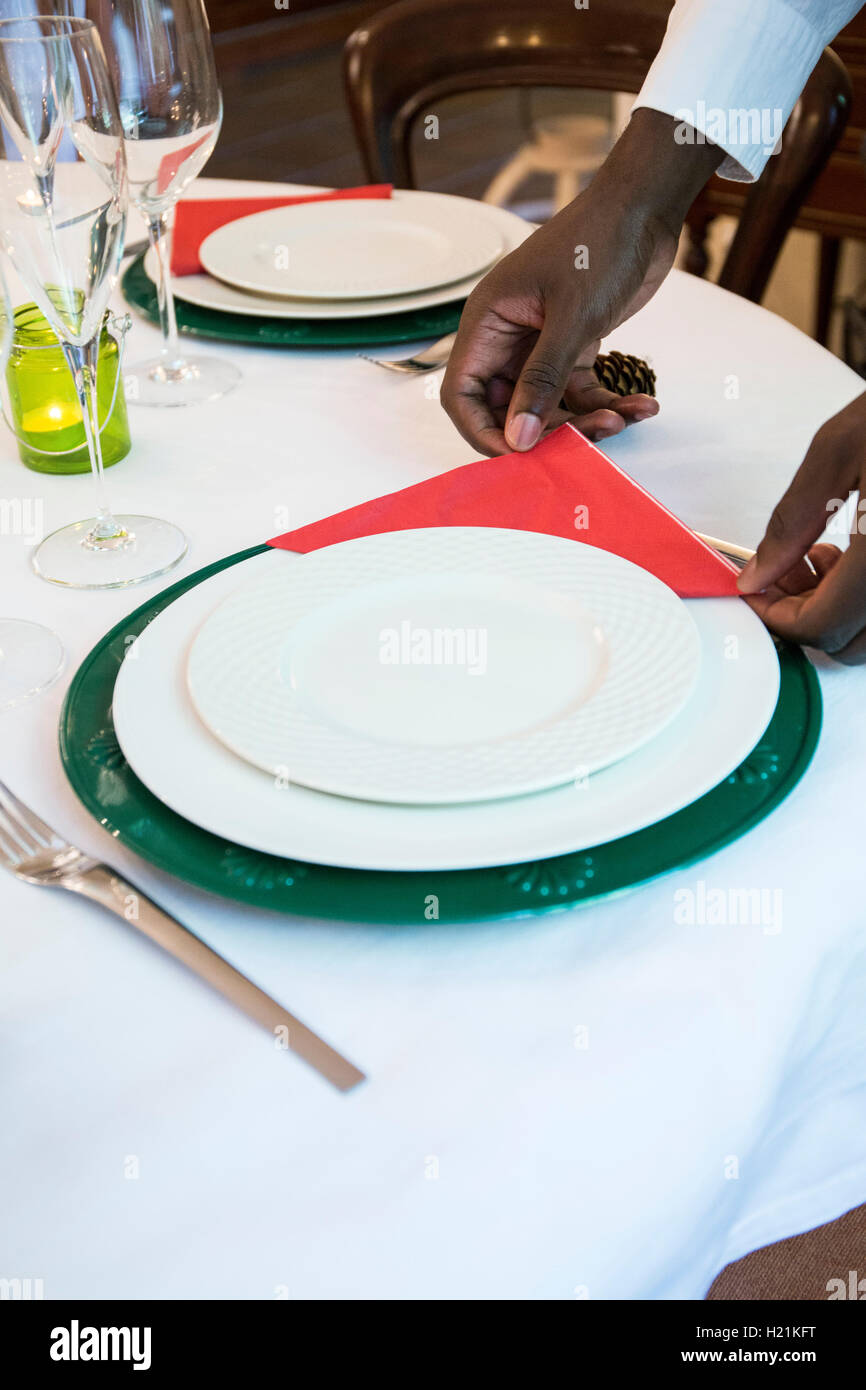 Man setting the table for Christmas dinner Stock Photo - Alamy