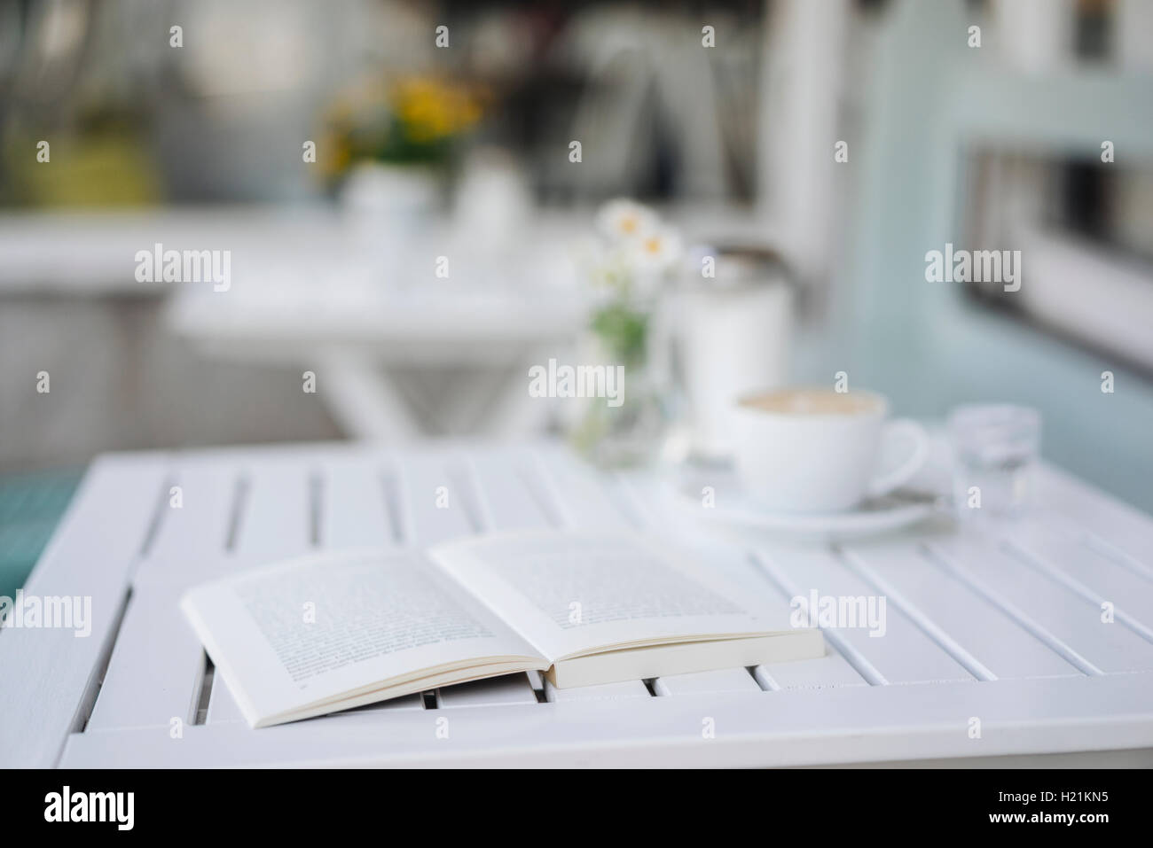 Book on table in a cafe Stock Photo - Alamy