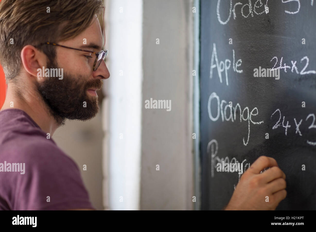 Man writing on chalkboard Stock Photo - Alamy