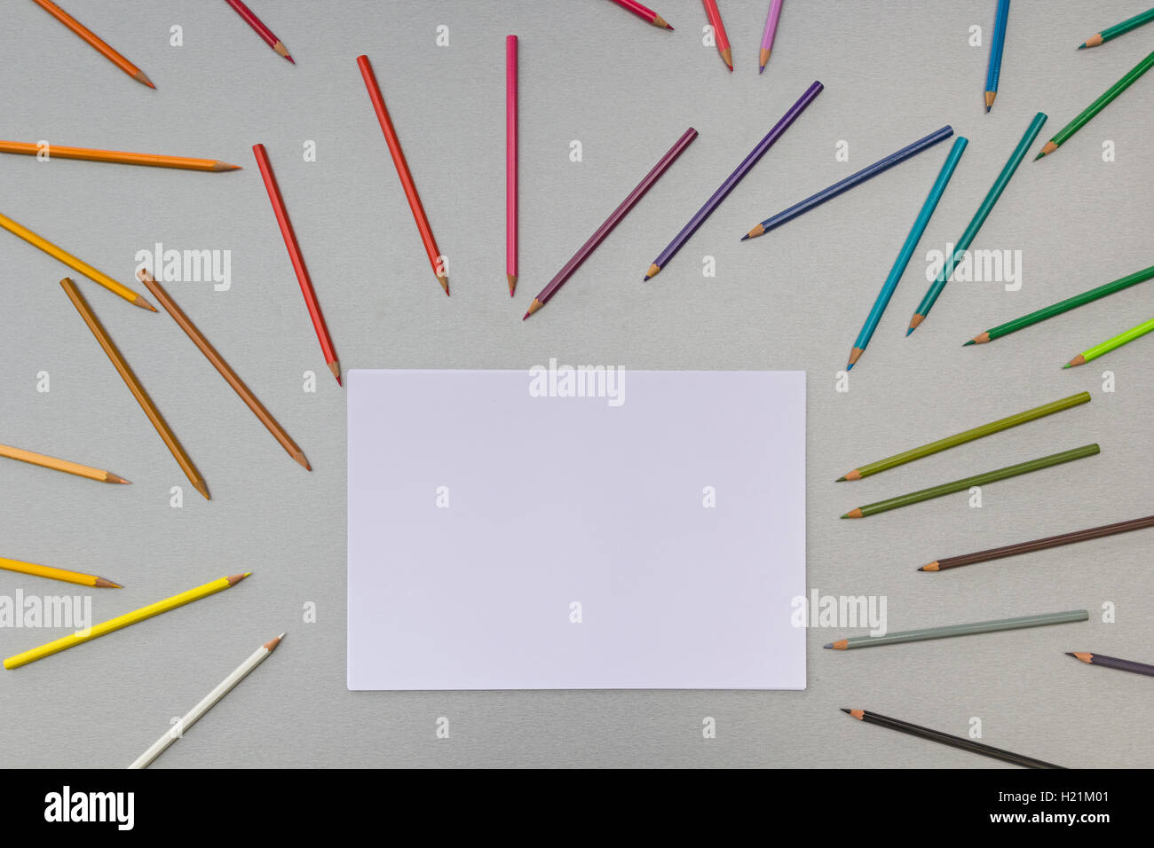 Coloured pencils and a blank sheet of paper Stock Photo - Alamy
