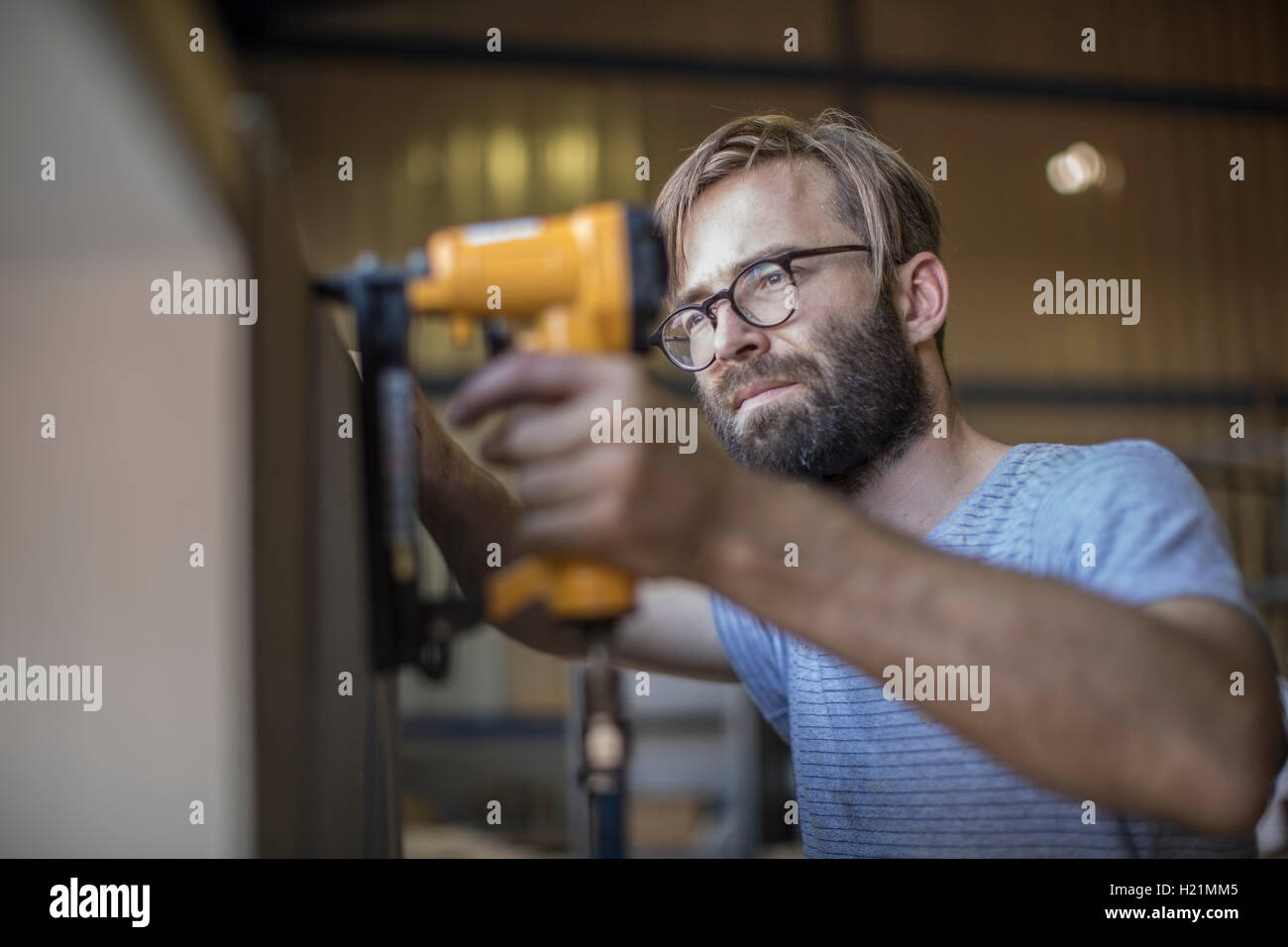 Carpenter using a staple gun Stock Photo - Alamy