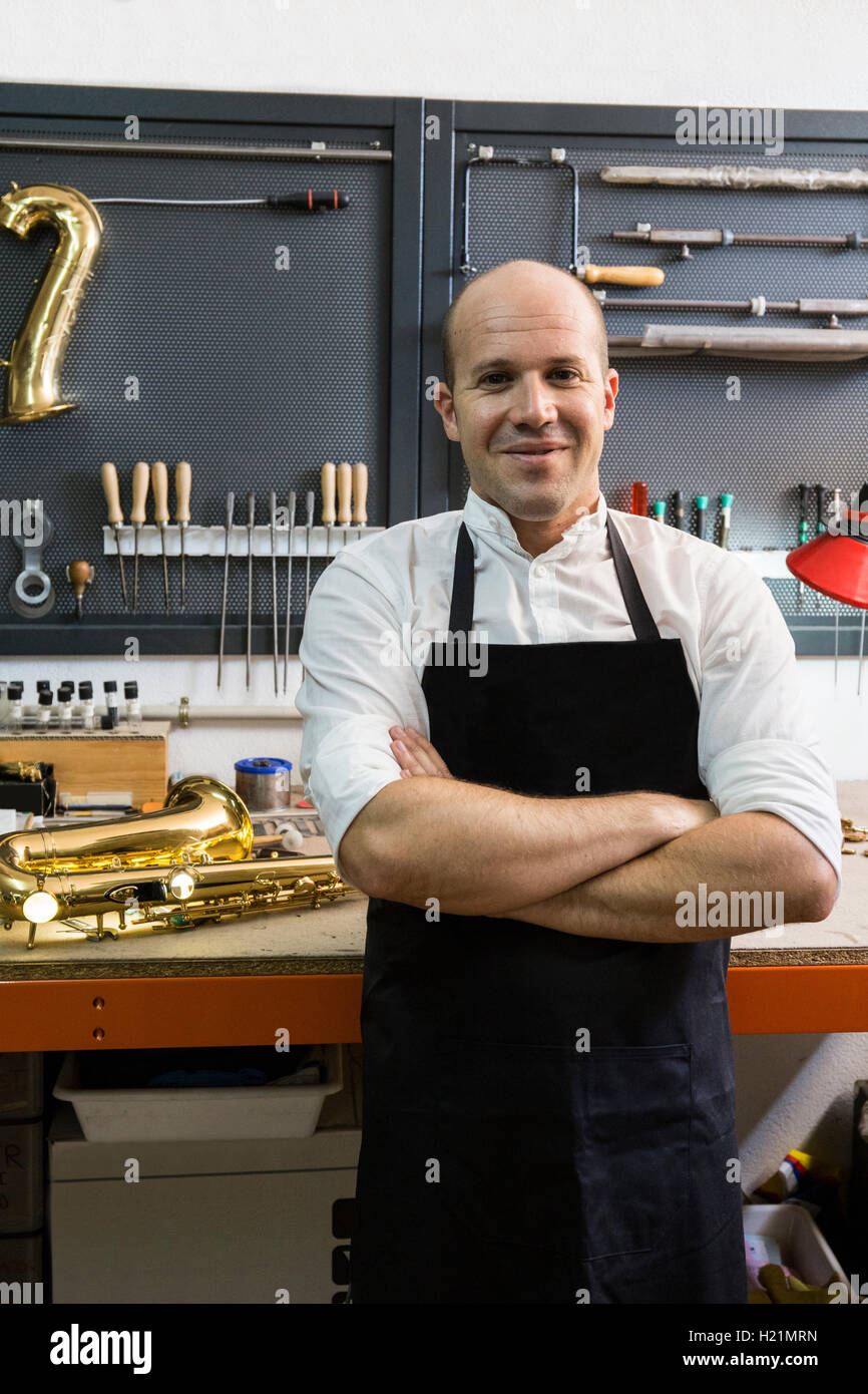Portrait of a smiling instrument maker in his workshop Stock Photo - Alamy