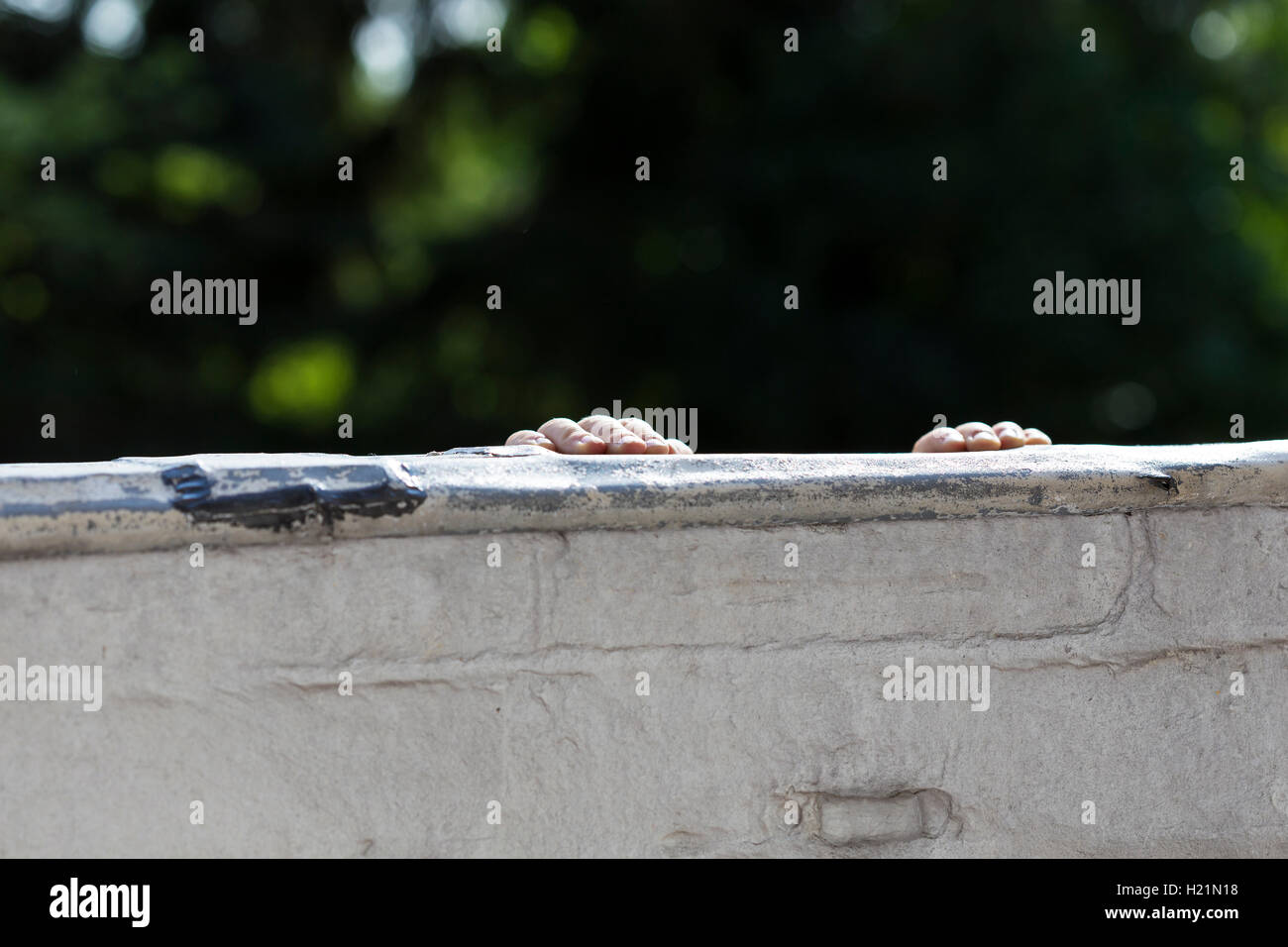 Hands of little girl climbing on a wall Stock Photo - Alamy