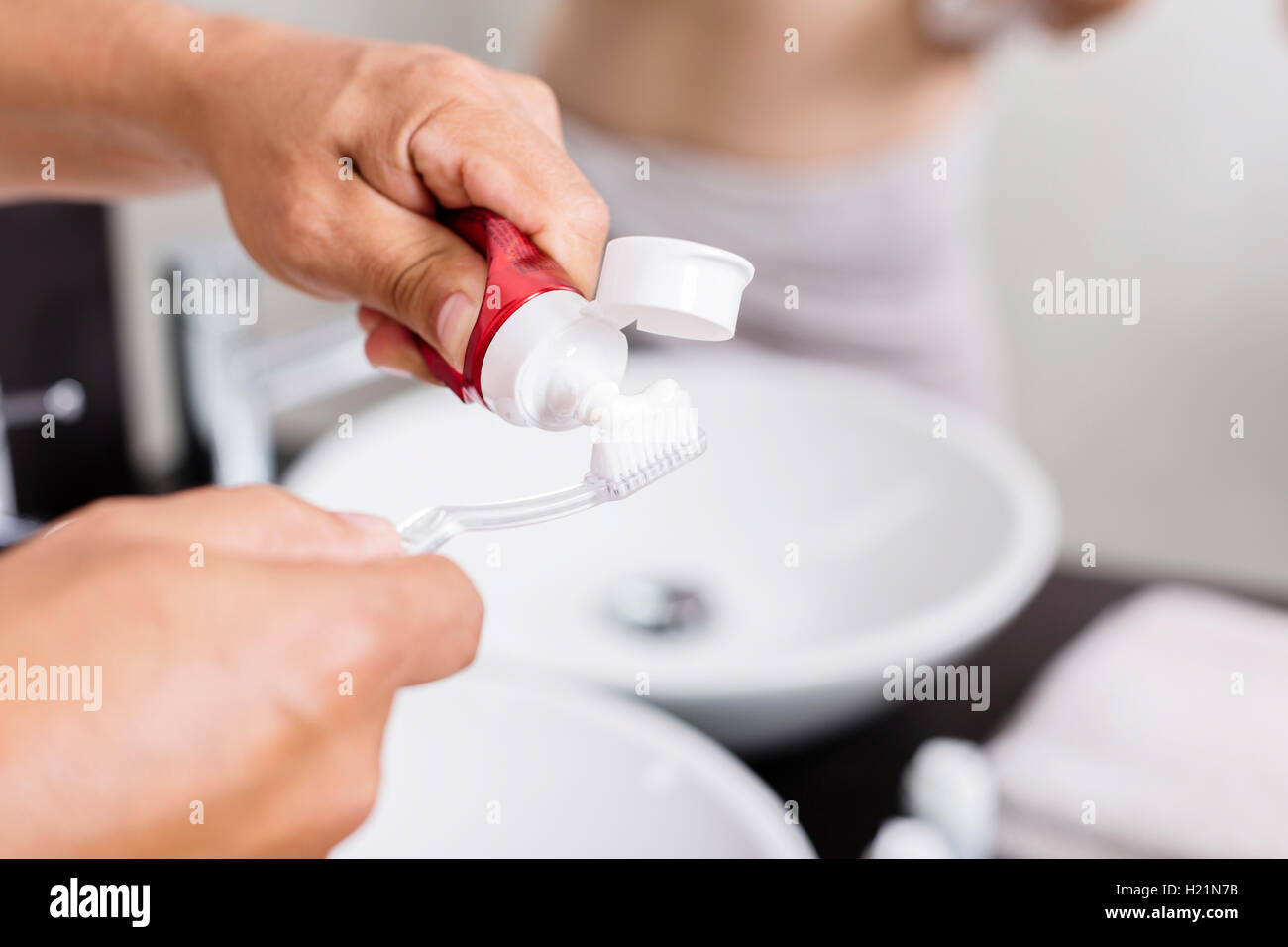 Applying toothpaste on toothbrush hi-res stock photography and images ...